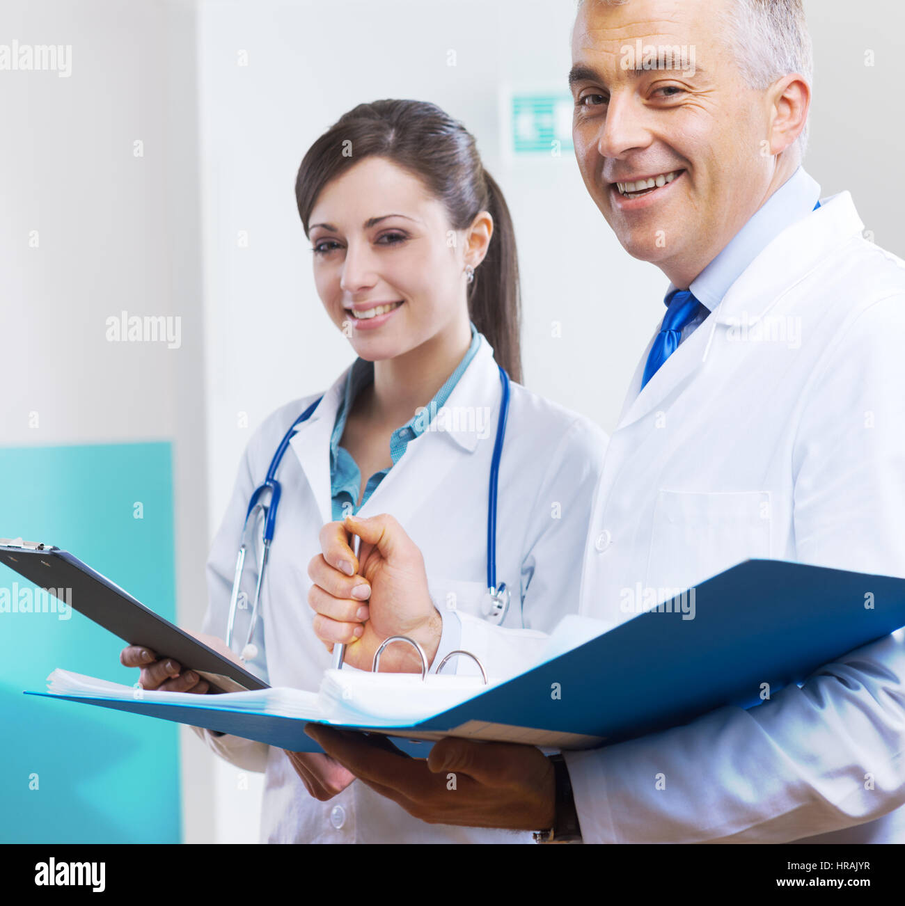 Young assistant and doctor checking medical records and documents Stock ...