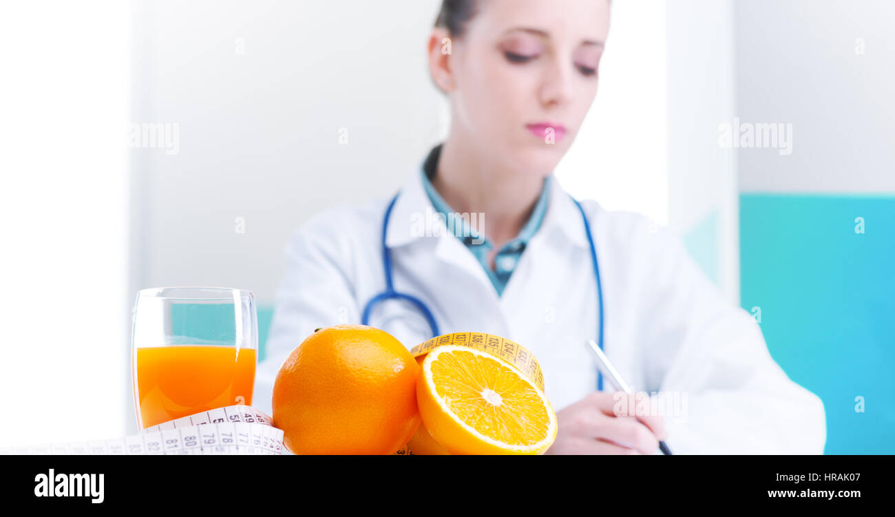 Nutritionist Doctor is writing a diet plan Stock Photo - Alamy