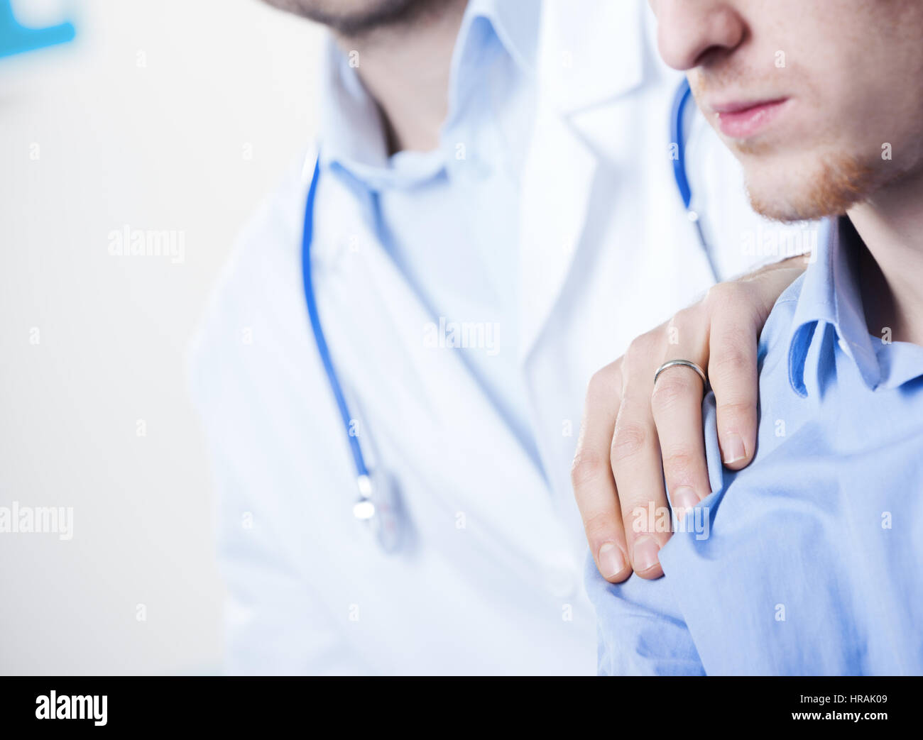 Doctor comforting a young patient after telling him bad news Stock ...