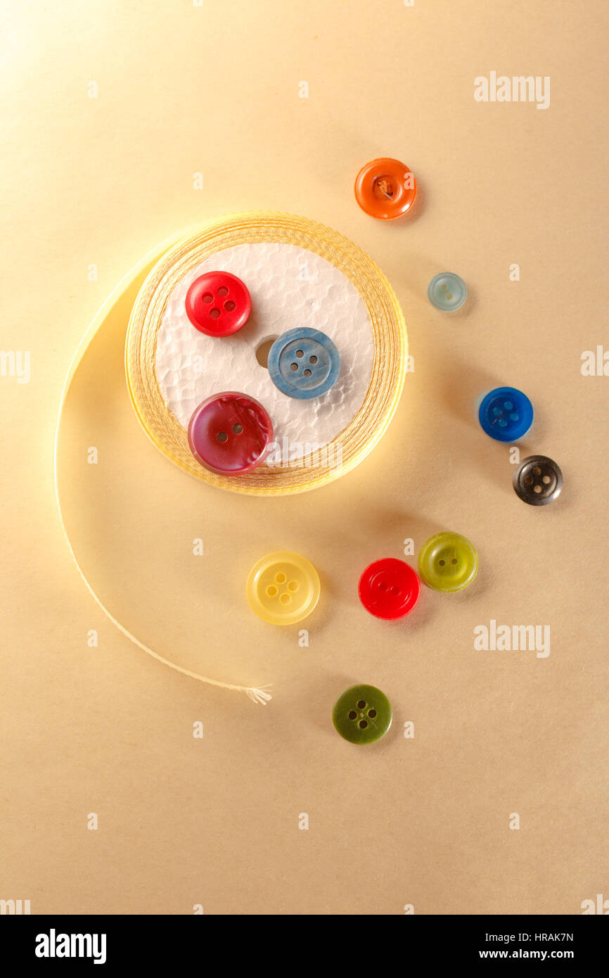 Colourful buttons and ribbon roll in closeup Stock Photo - Alamy