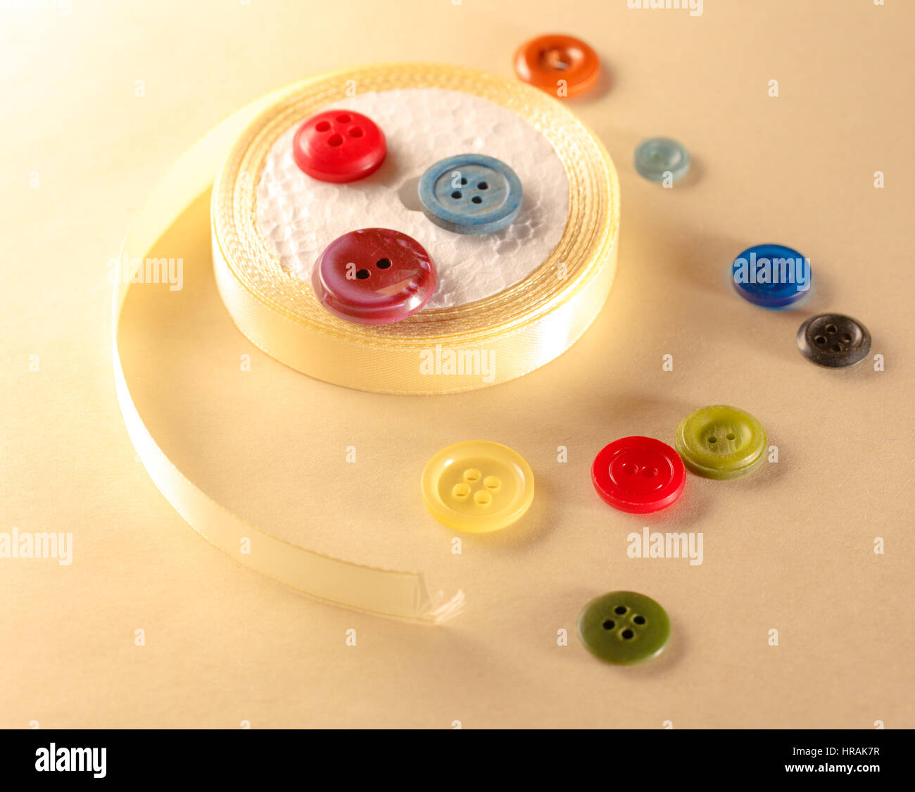 Colourful buttons and ribbon roll in closeup Stock Photo - Alamy