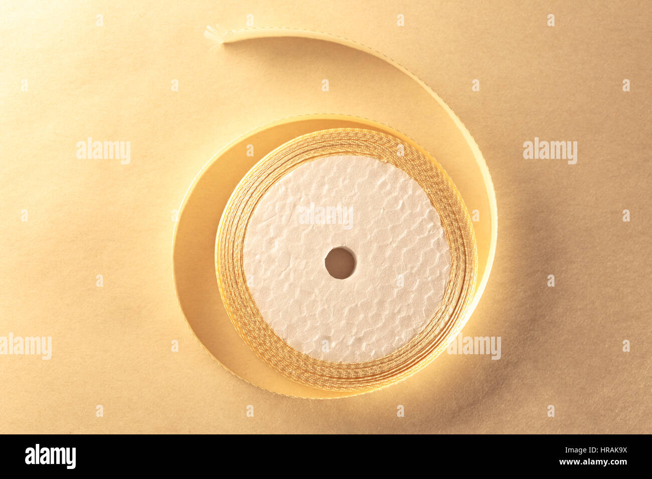 Cream ribbon in roll on paper background Stock Photo - Alamy