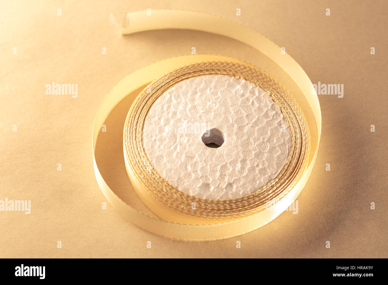 Cream ribbon in roll on paper background Stock Photo - Alamy
