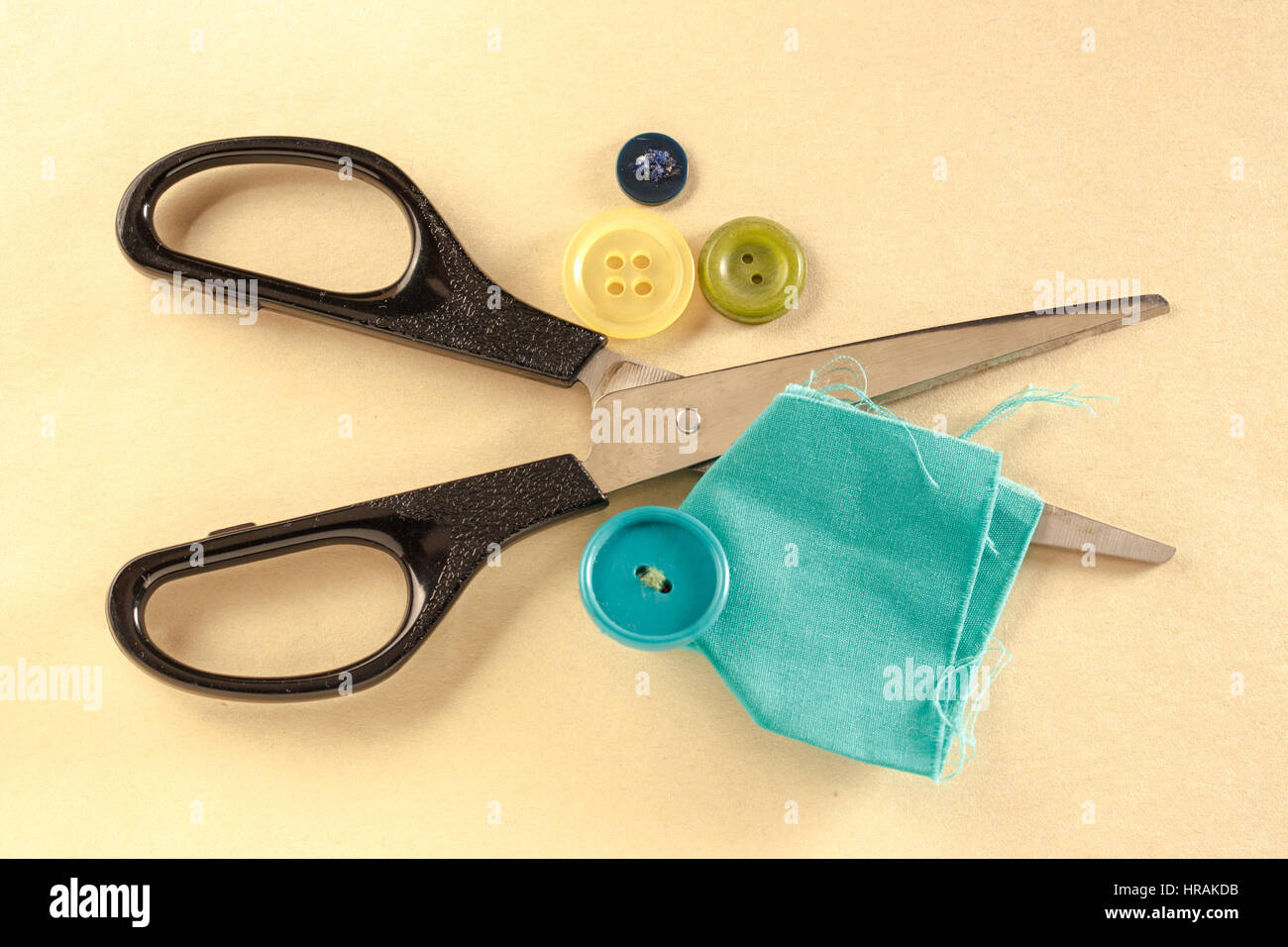 Colourful buttons, scissors and cloth in closeup Stock Photo - Alamy