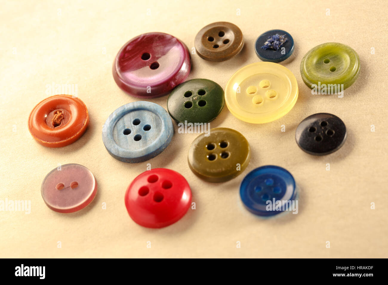 Colourful buttons on paper background in closeup Stock Photo - Alamy