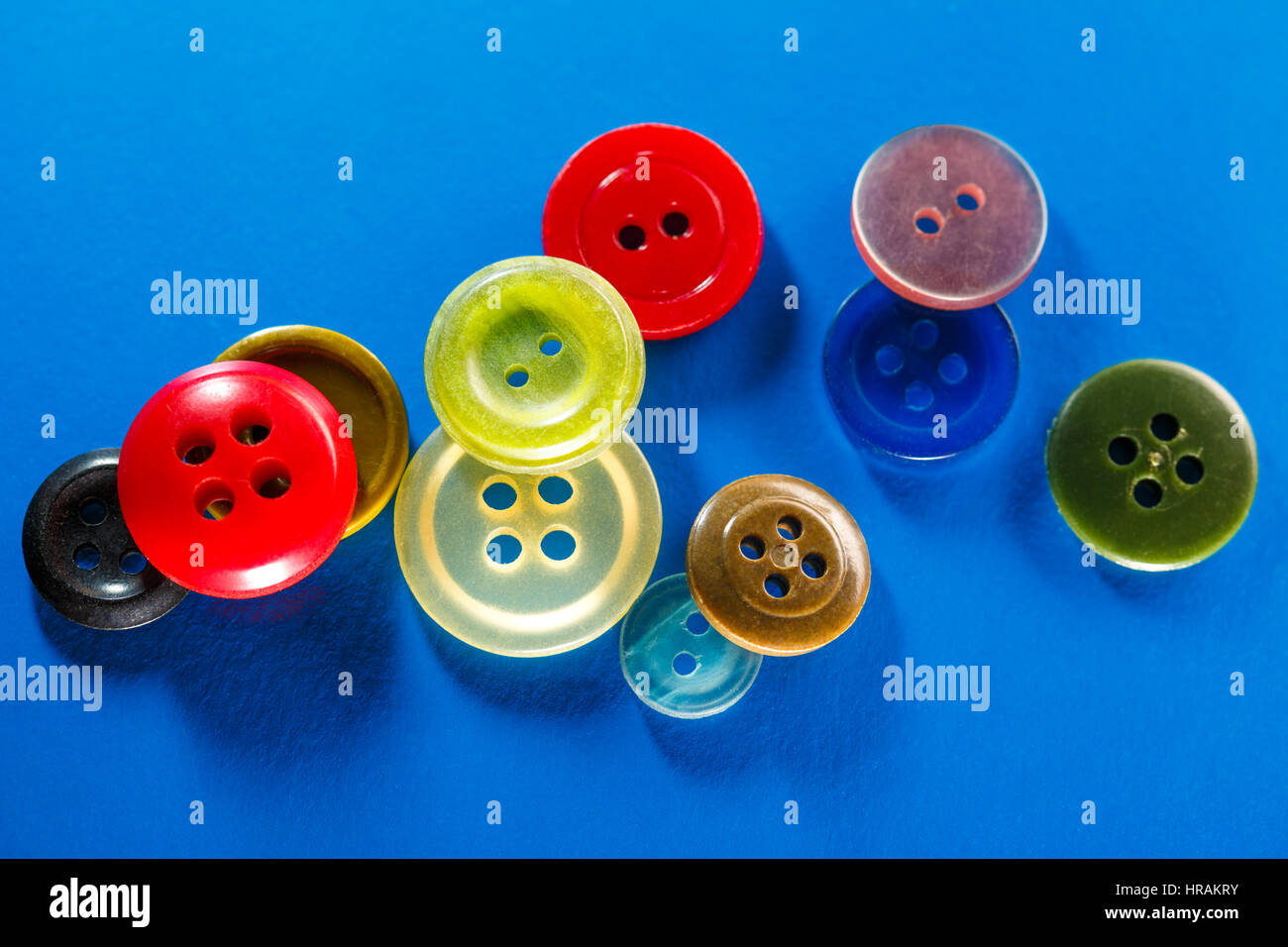 Colourful buttons on blue background in closeup Stock Photo - Alamy
