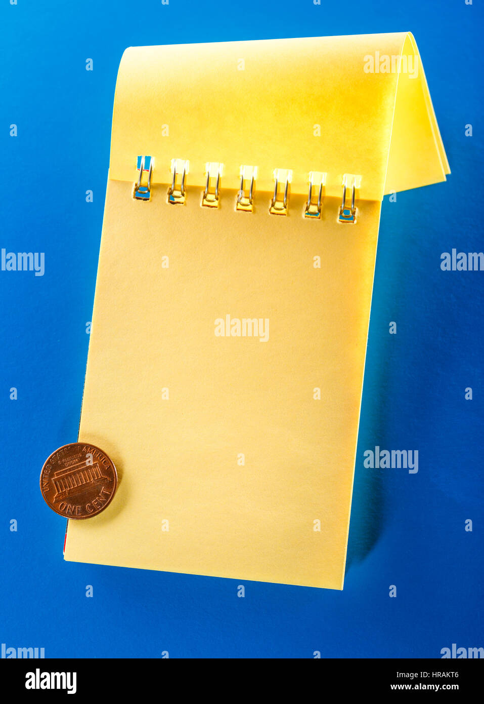 Blank open notebook with cent on the blue background Stock Photo - Alamy