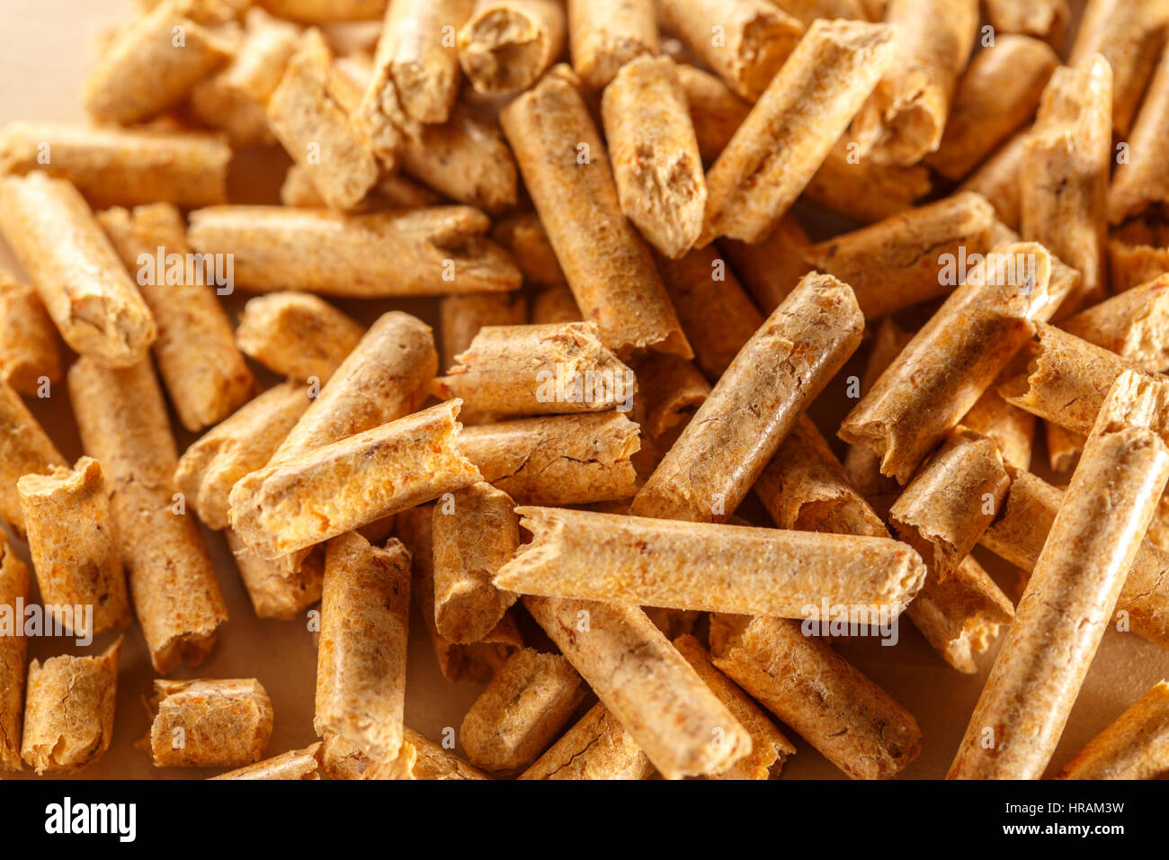 Wooden pellets on paper background in closeup Stock Photo - Alamy