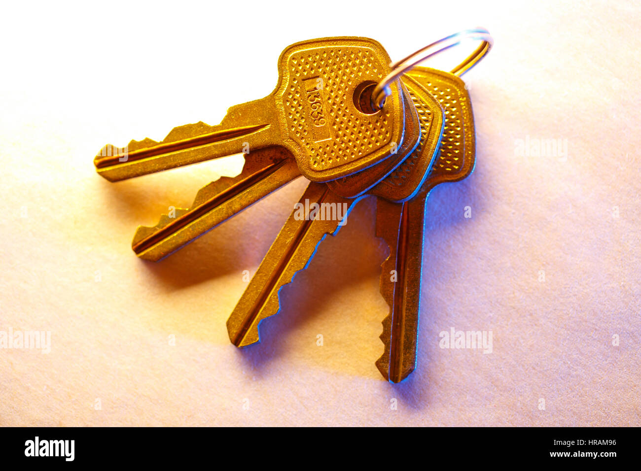 Metal keys on paper background in closeup Stock Photo - Alamy