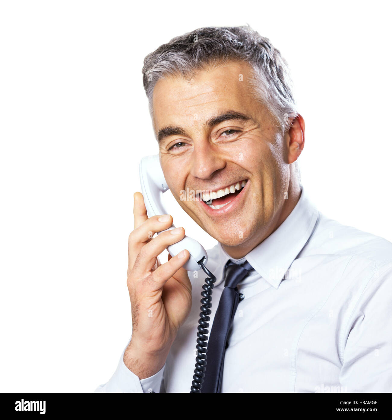 Attractive confident businessman talking on the phone on white ...