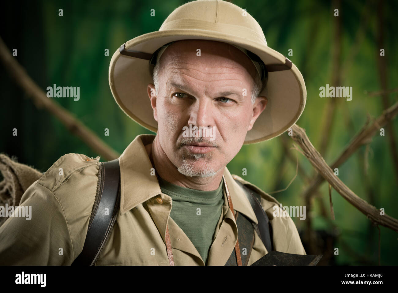Adventurer in the jungle with equipment exploring and looking around ...