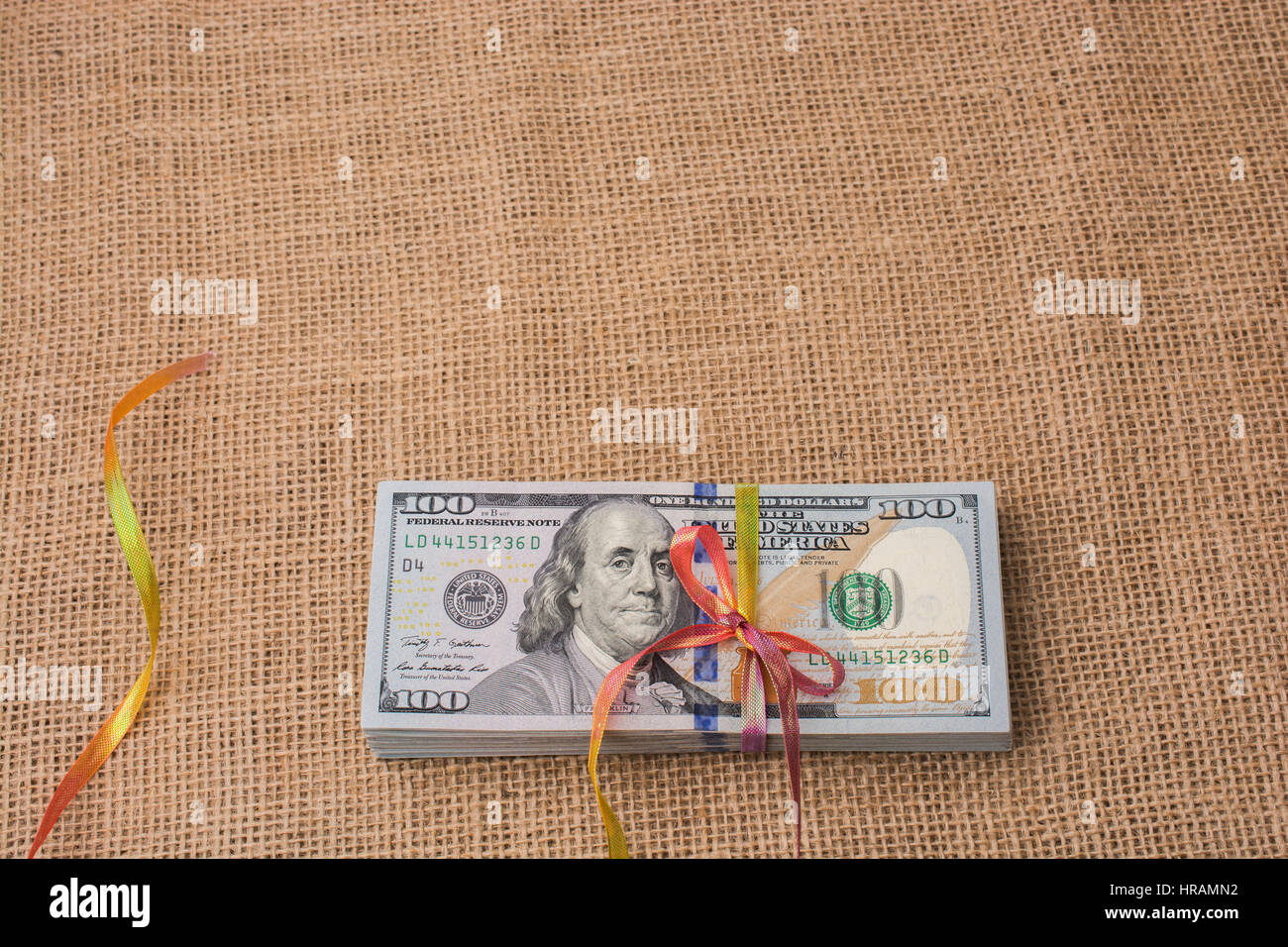 Banknote bundle of US dollar tied with colorful a ribbon Stock Photo ...