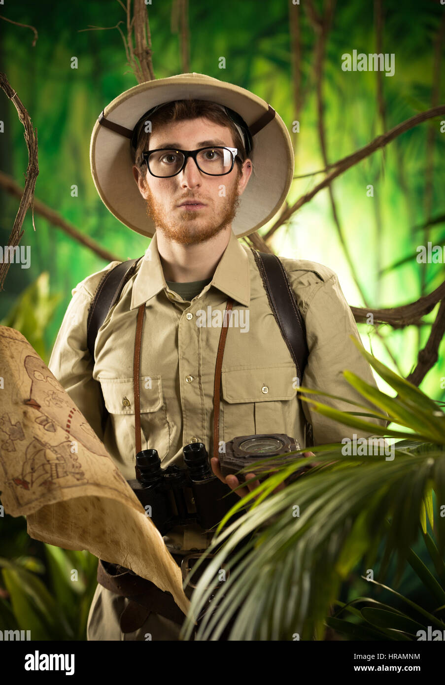 Young adventurer with map and compass exploring the rainforest jungle ...