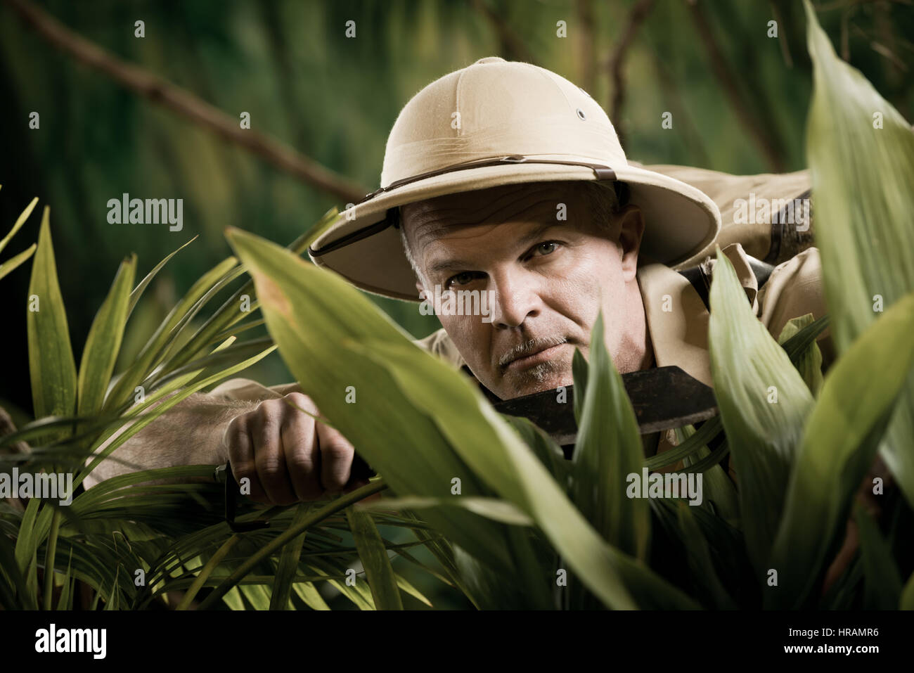 Survival confident adventurer exploring the rainforest jungle holding a ...