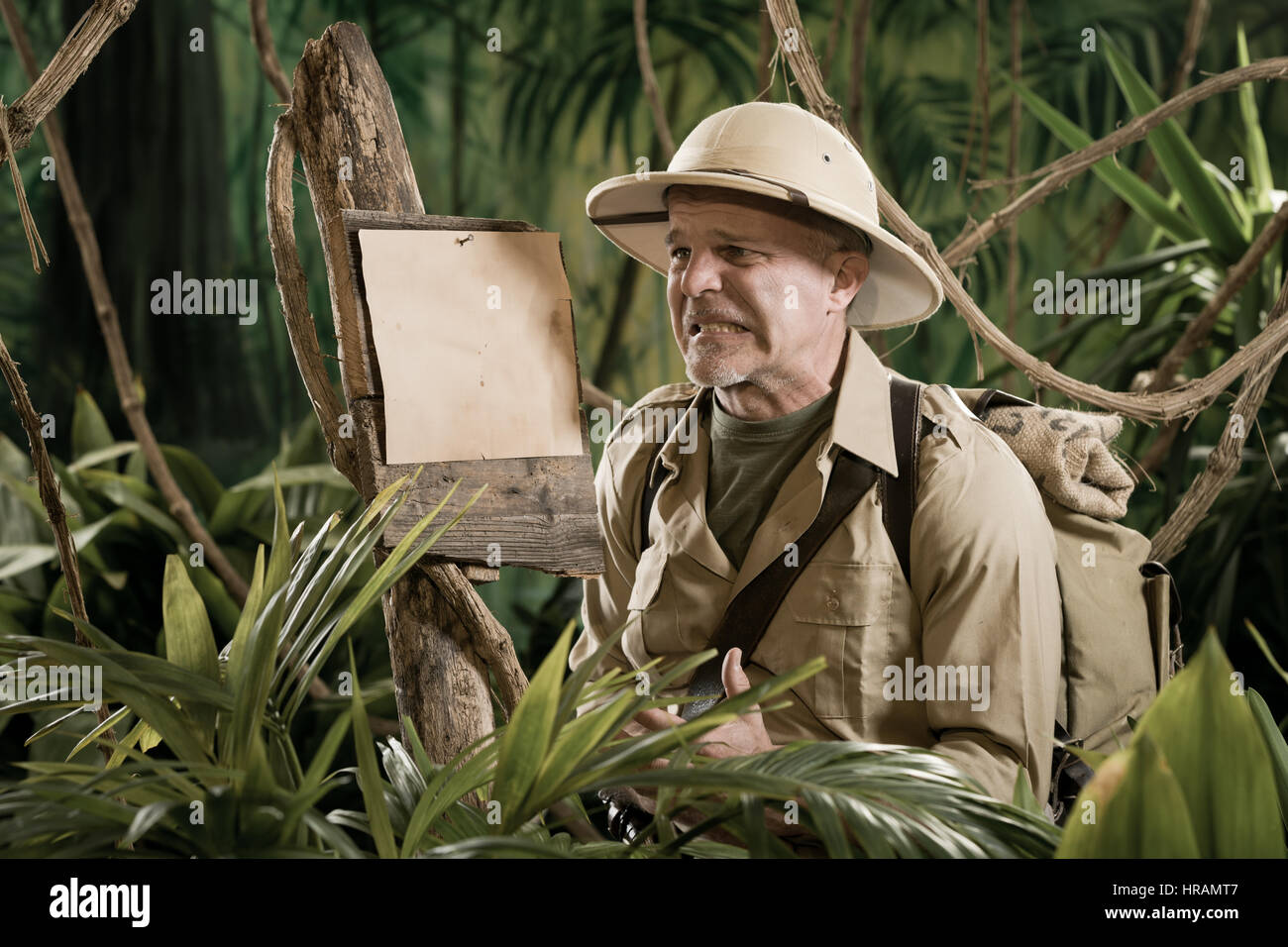 Disappointed funny explorer looking for a toilet in the jungle Stock ...