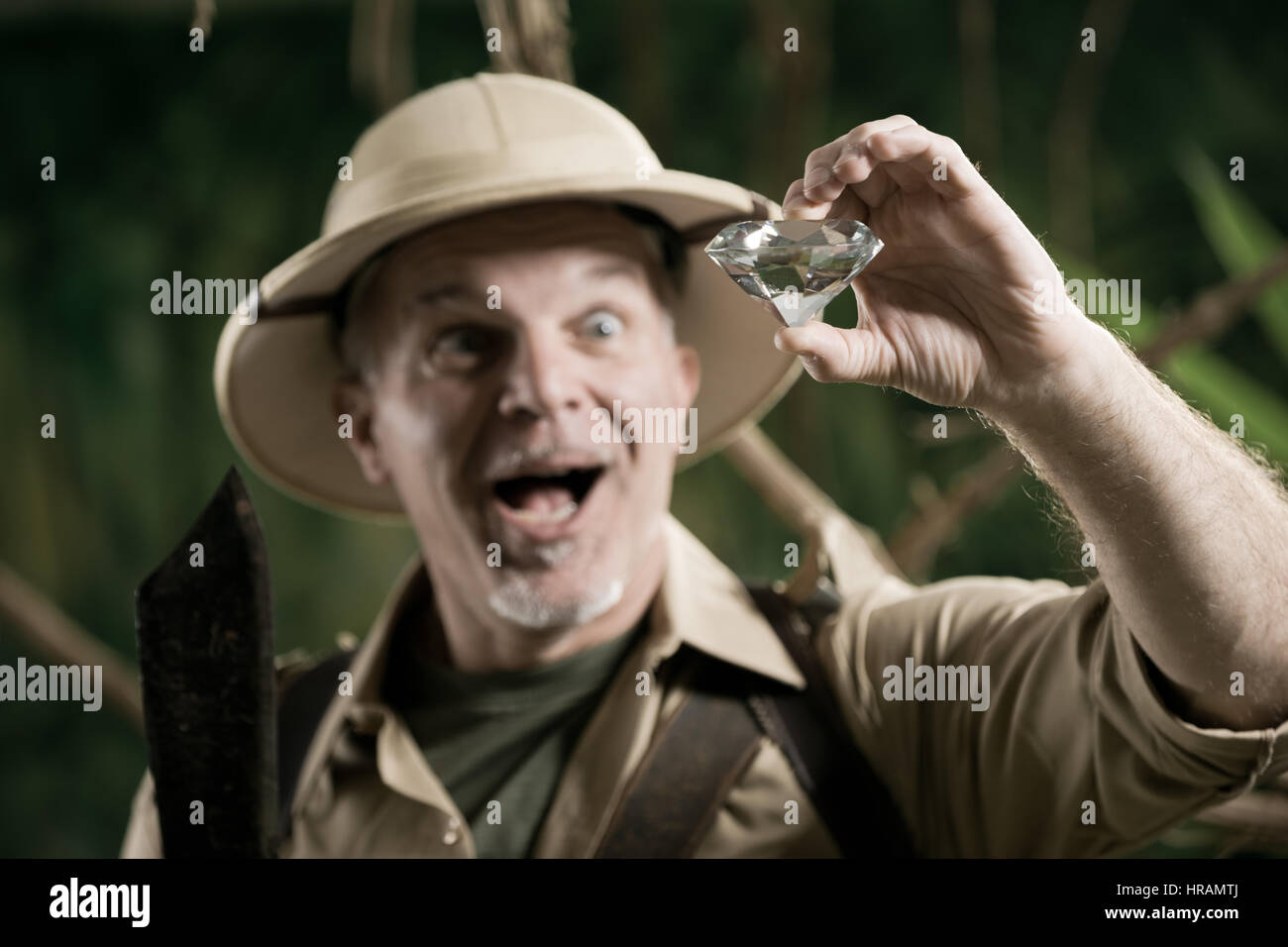 Surprised explorer finding a huge precious diamond in the jungle Stock ...