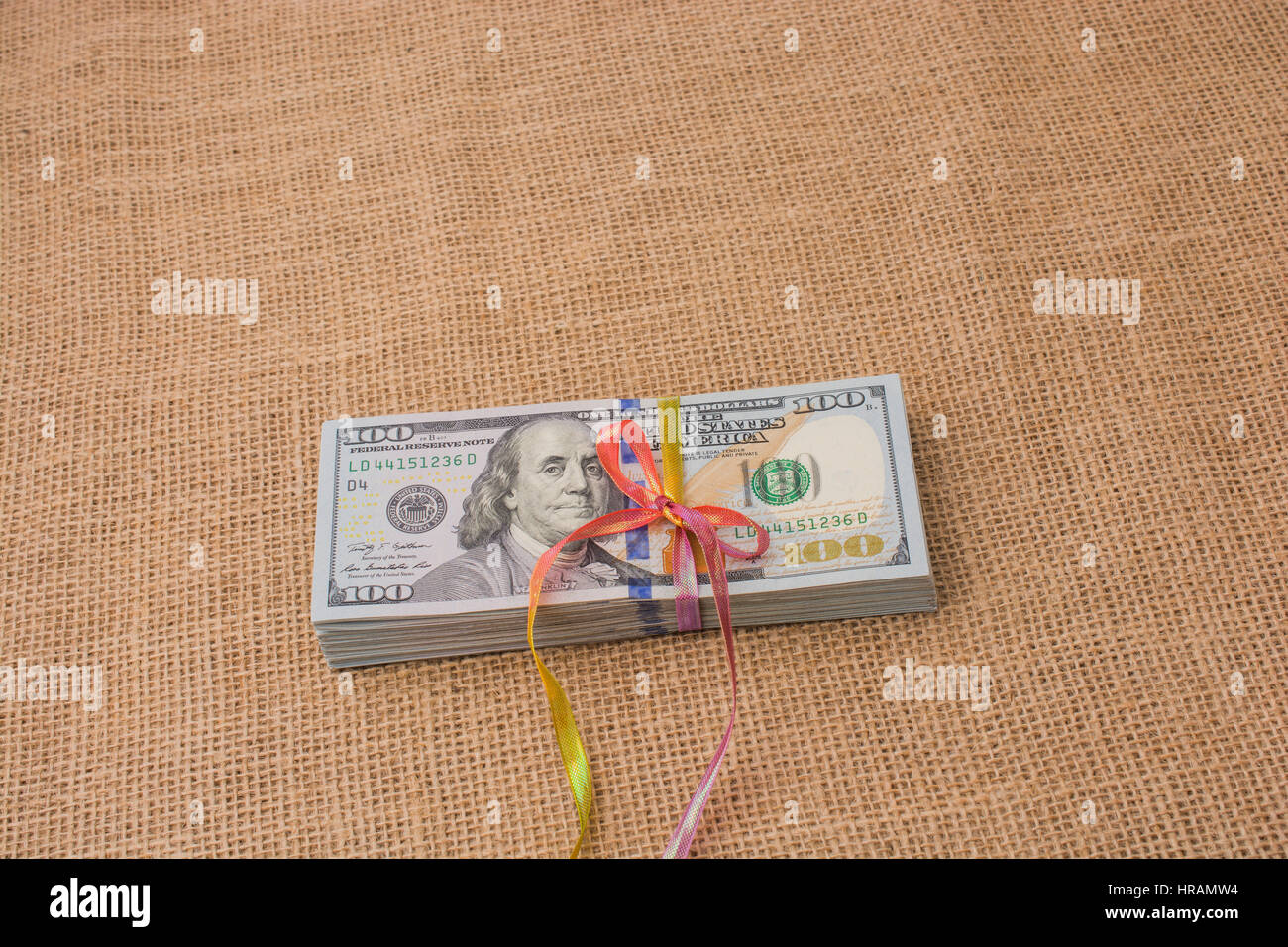 Banknote bundle of US dollar tied with colorful a ribbon Stock Photo ...
