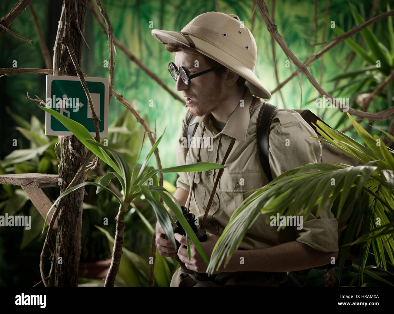 Young colonial style explorer in the jungle finding an exit sign Stock ...