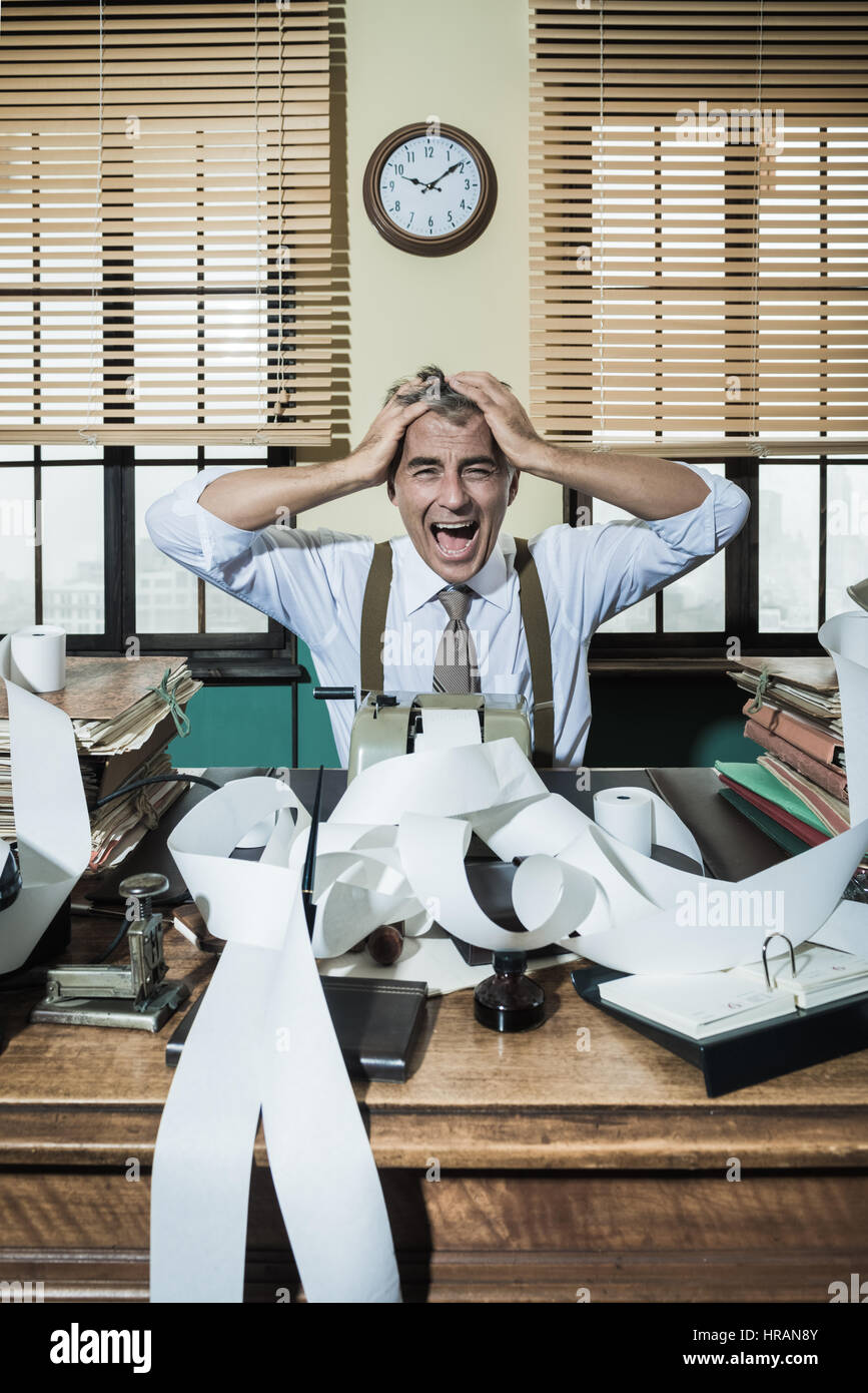 Desperate accountant shouting head in hands in vintage 1950s style ...