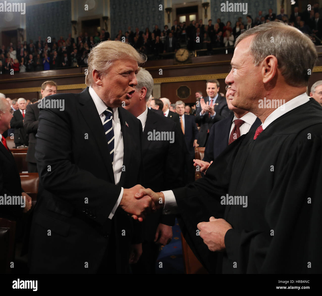 US President Donald J. Trump (L) shakes hands with Chief Justice John ...