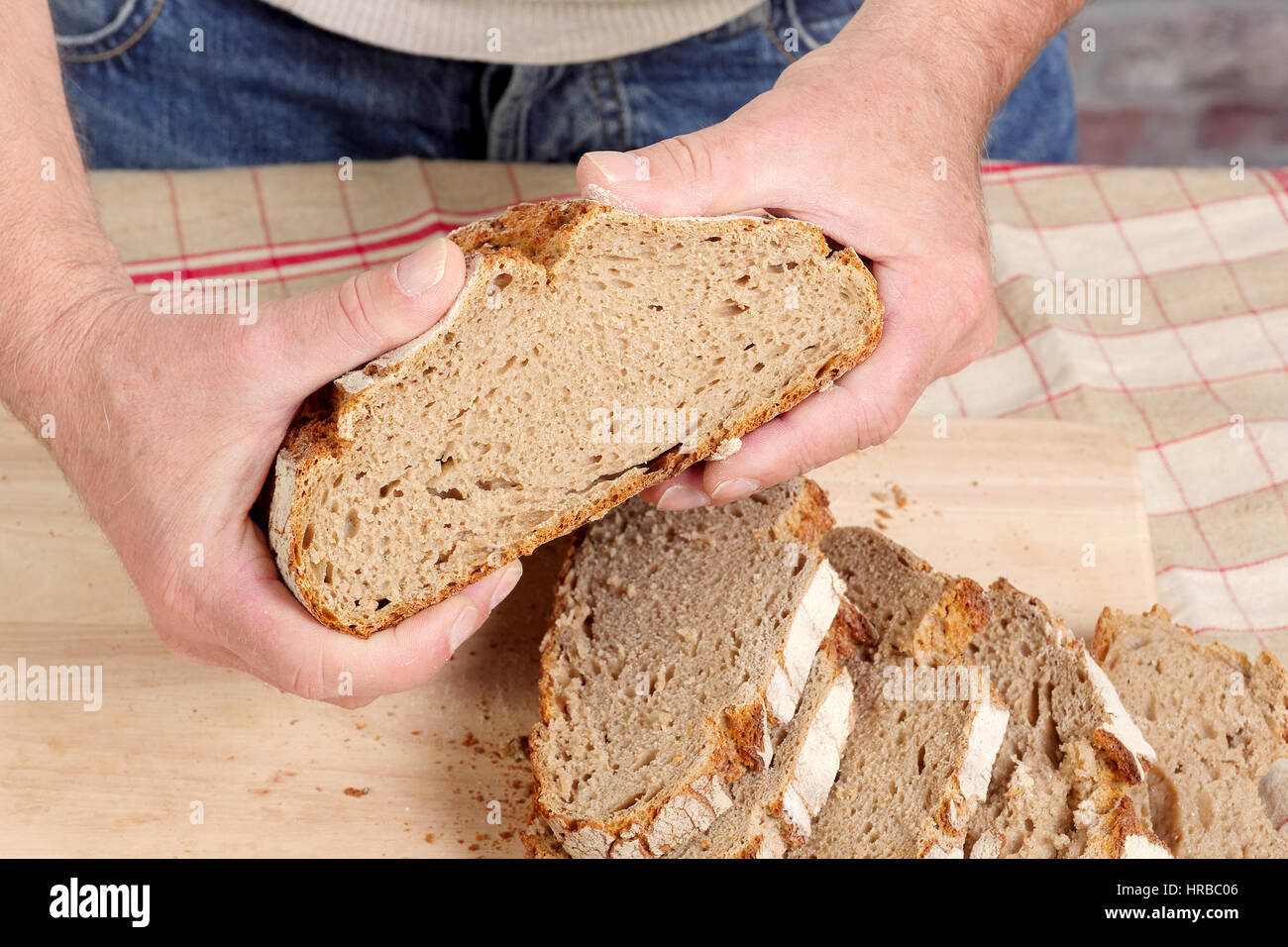 the man hands with fresh bread on wood table Stock Photo - Alamy