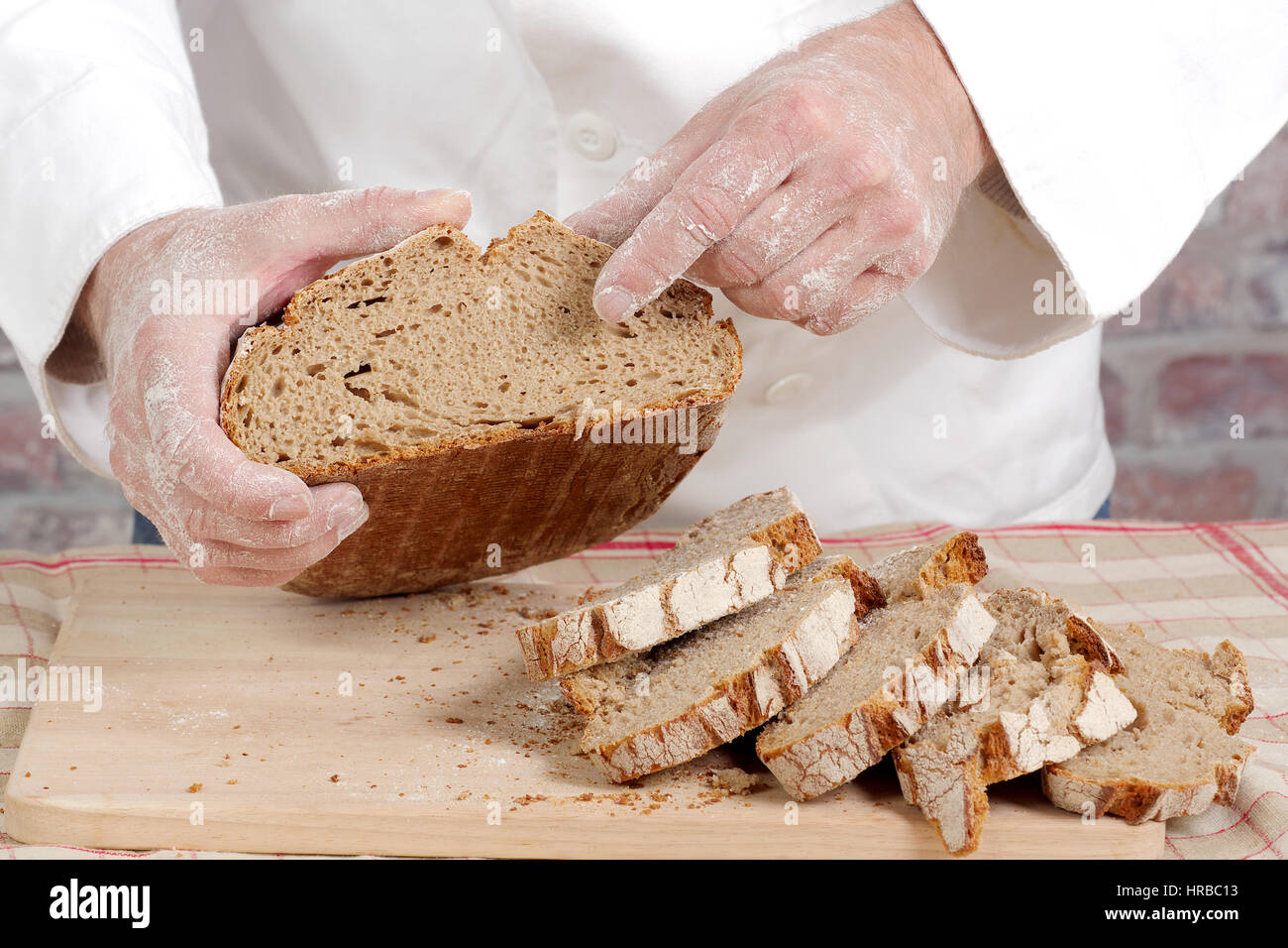 a baker hands with fresh bread on wood table Stock Photo - Alamy
