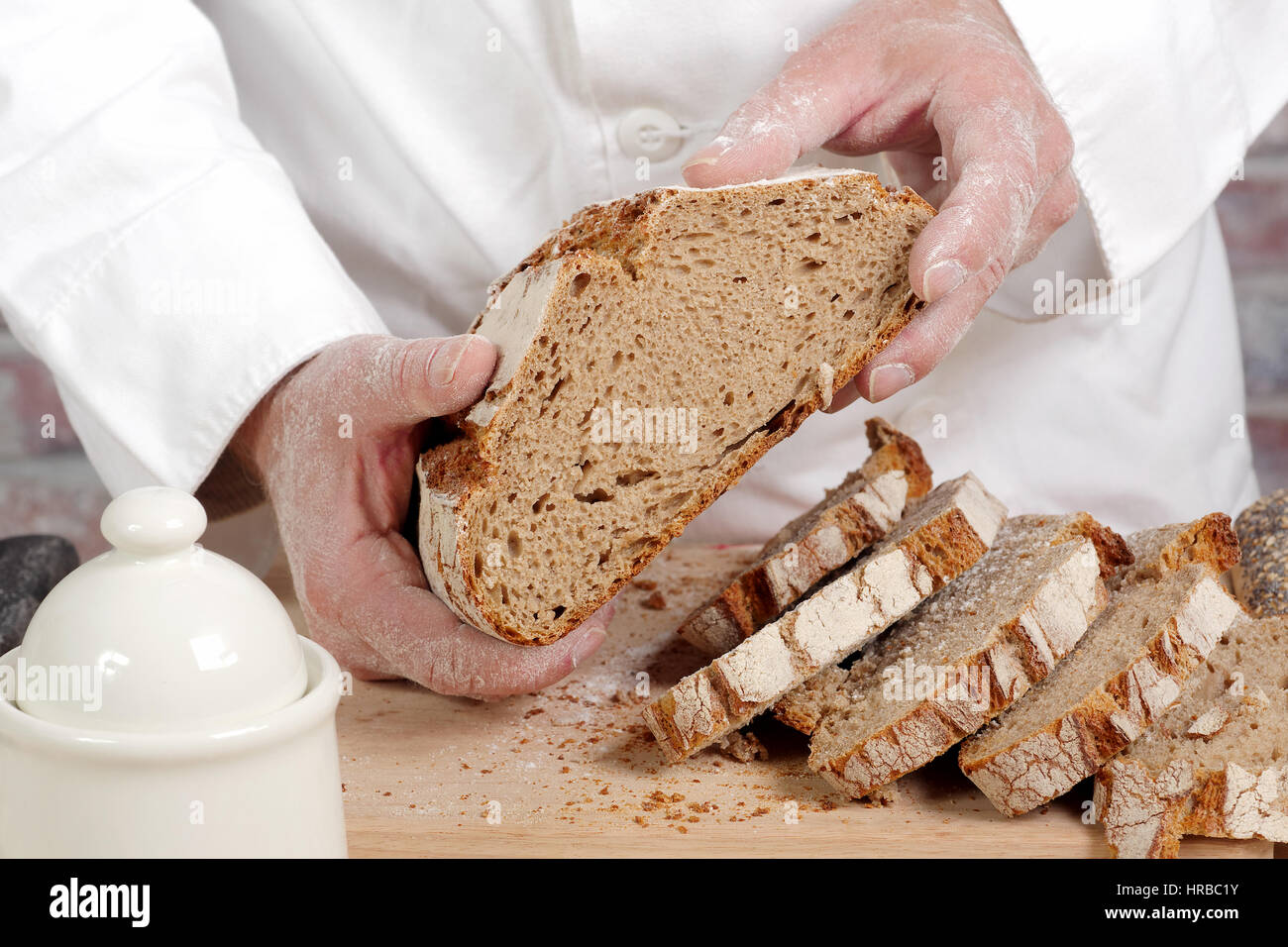 a baker hands with fresh bread on wood table Stock Photo - Alamy