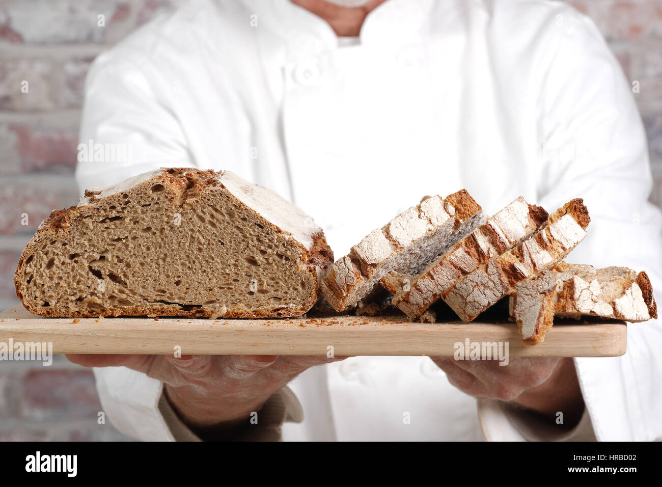a baker hands with fresh bread on wood table Stock Photo - Alamy