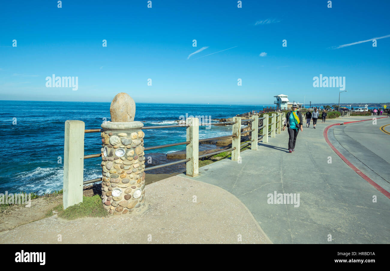 Group of people on walking on a sidewalk along the La Jolla, California ...