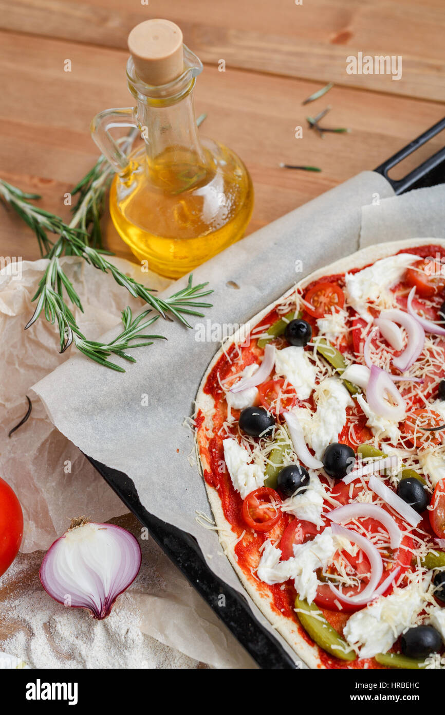 homemade pizza cooking on natural wooden table Stock Photo - Alamy