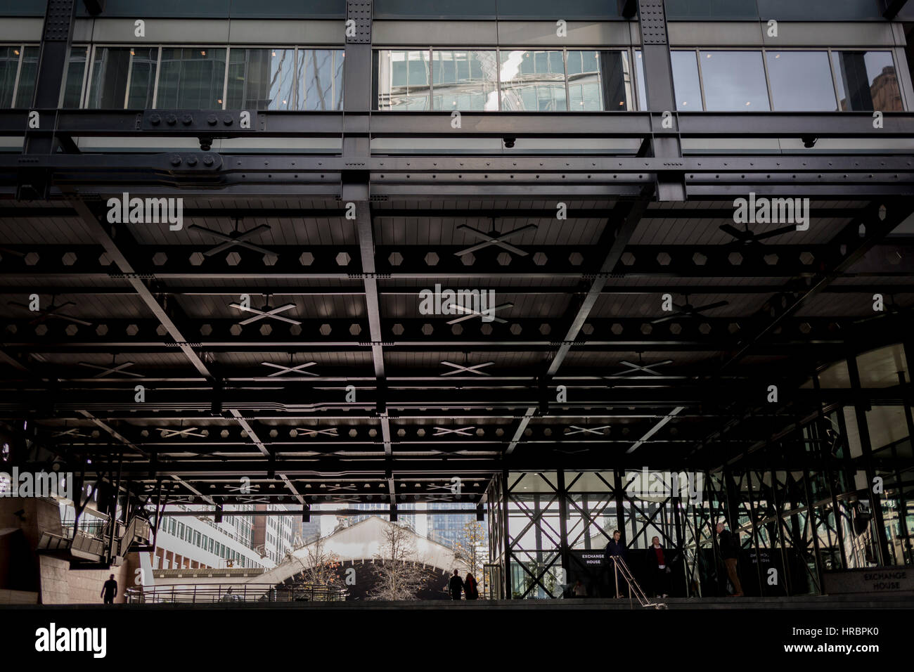 City workers walk beneath the girders of Thatcherite architecture, on ...