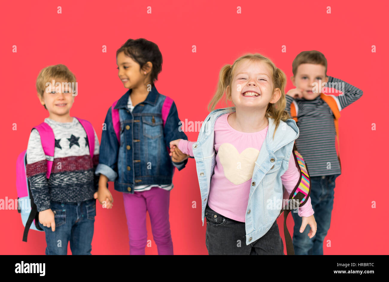 Little Kids Holding Hands Carrying Backpacks Stock Photo - Alamy
