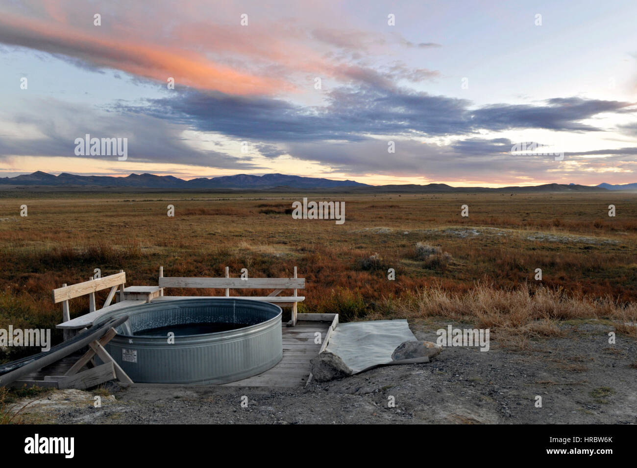 A man made pool for a natural hot spring. The pool is in the foreground ...