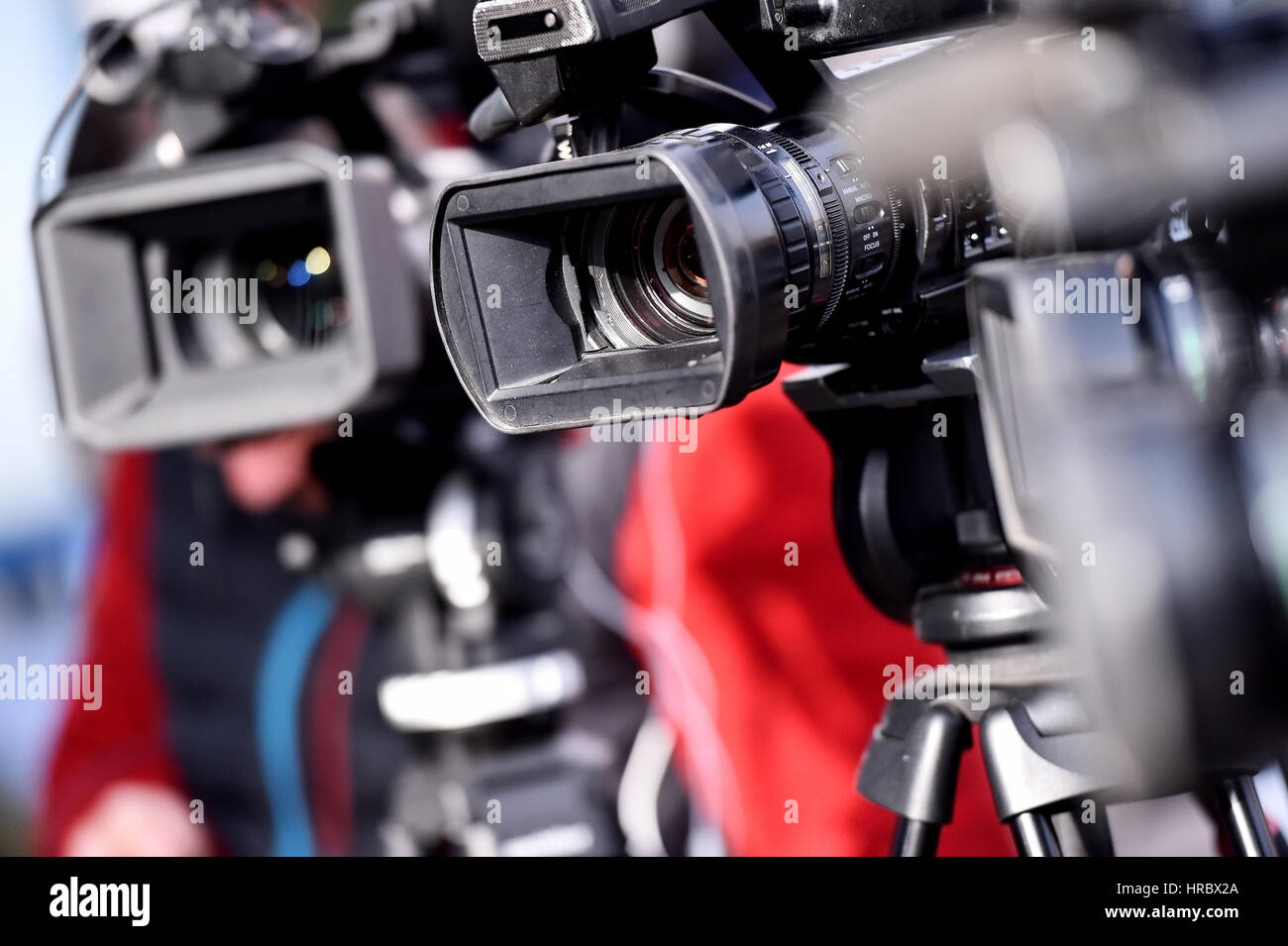 Lots of television cameras in a row broadcasting a live media event ...