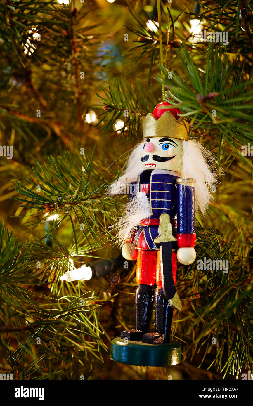 Nutcracker and lights hanging from a Christmas tree Stock Photo - Alamy