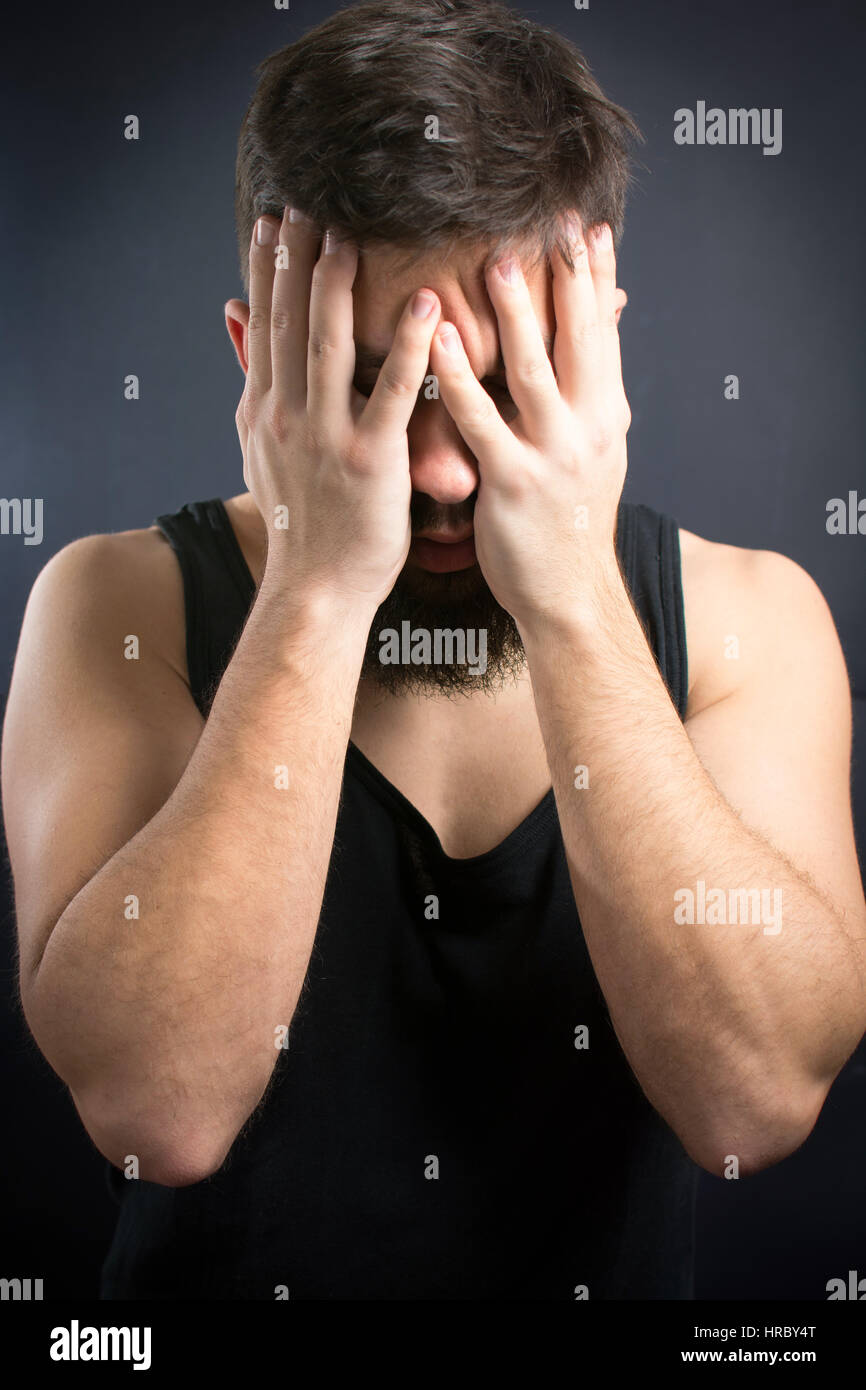Worried man with hands on his face Stock Photo - Alamy
