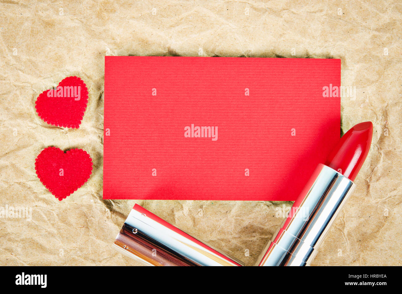 Empty red greeting card with red lipstick ready for your text on brown ...