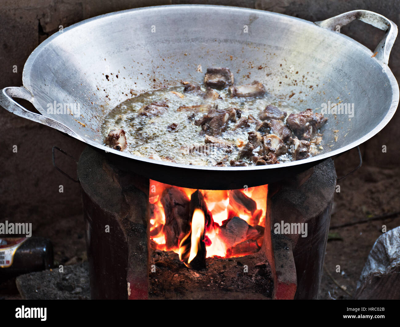 Cooking by a hot flame from charcoal Stock Photo - Alamy