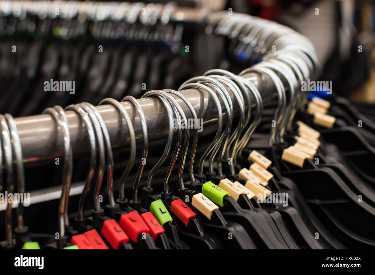 Many hangers on a rack in the store Stock Photo - Alamy