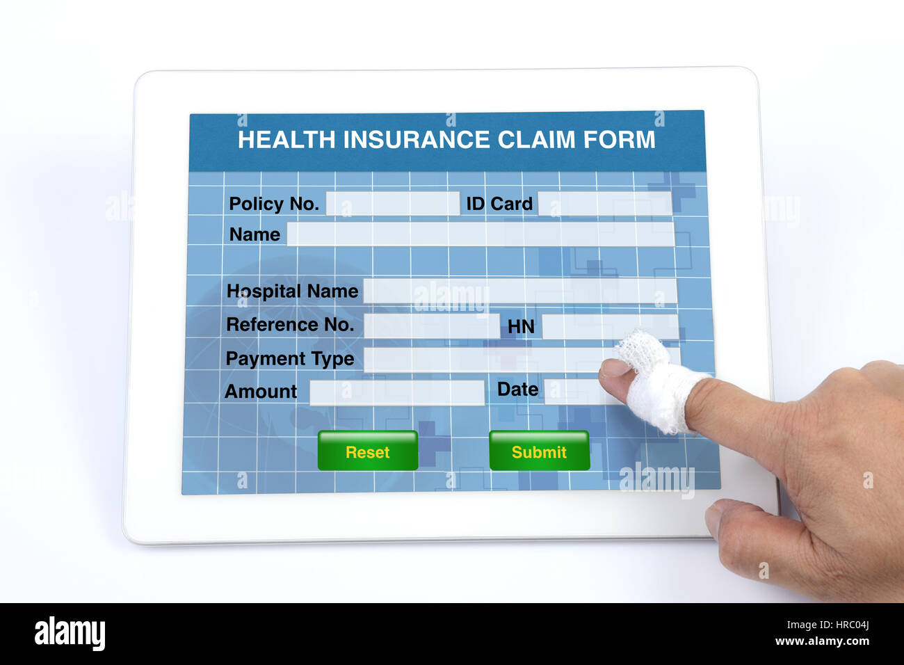 Someone using tablet to complete health insurance claim form on white ...