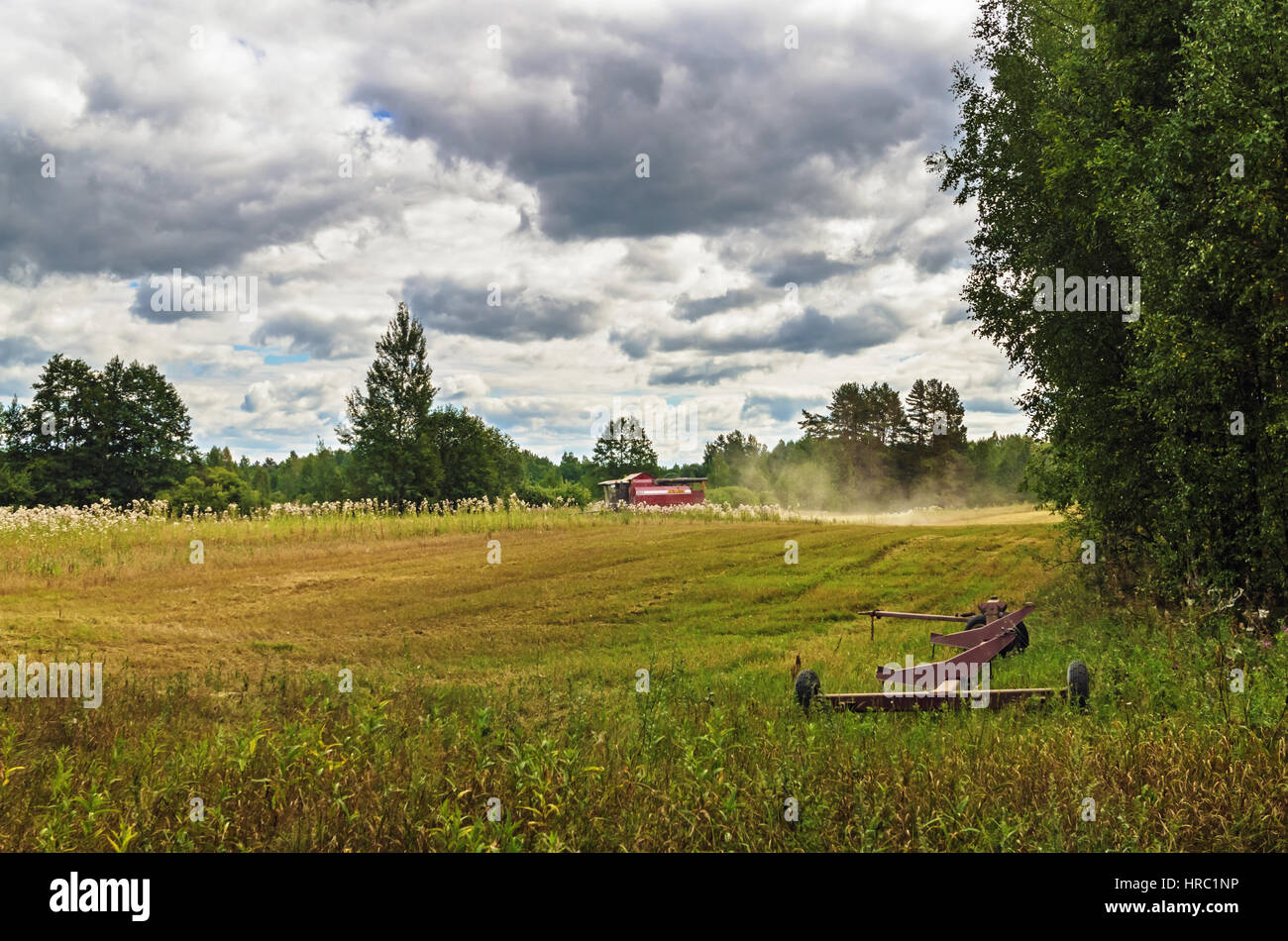 Cleaning agricultural field by harvester Stock Photo - Alamy