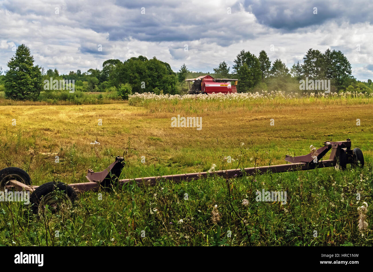 Cleaning agricultural field by harvester Stock Photo - Alamy