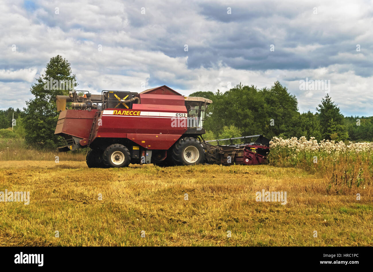 Cleaning agricultural field by harvester Stock Photo - Alamy