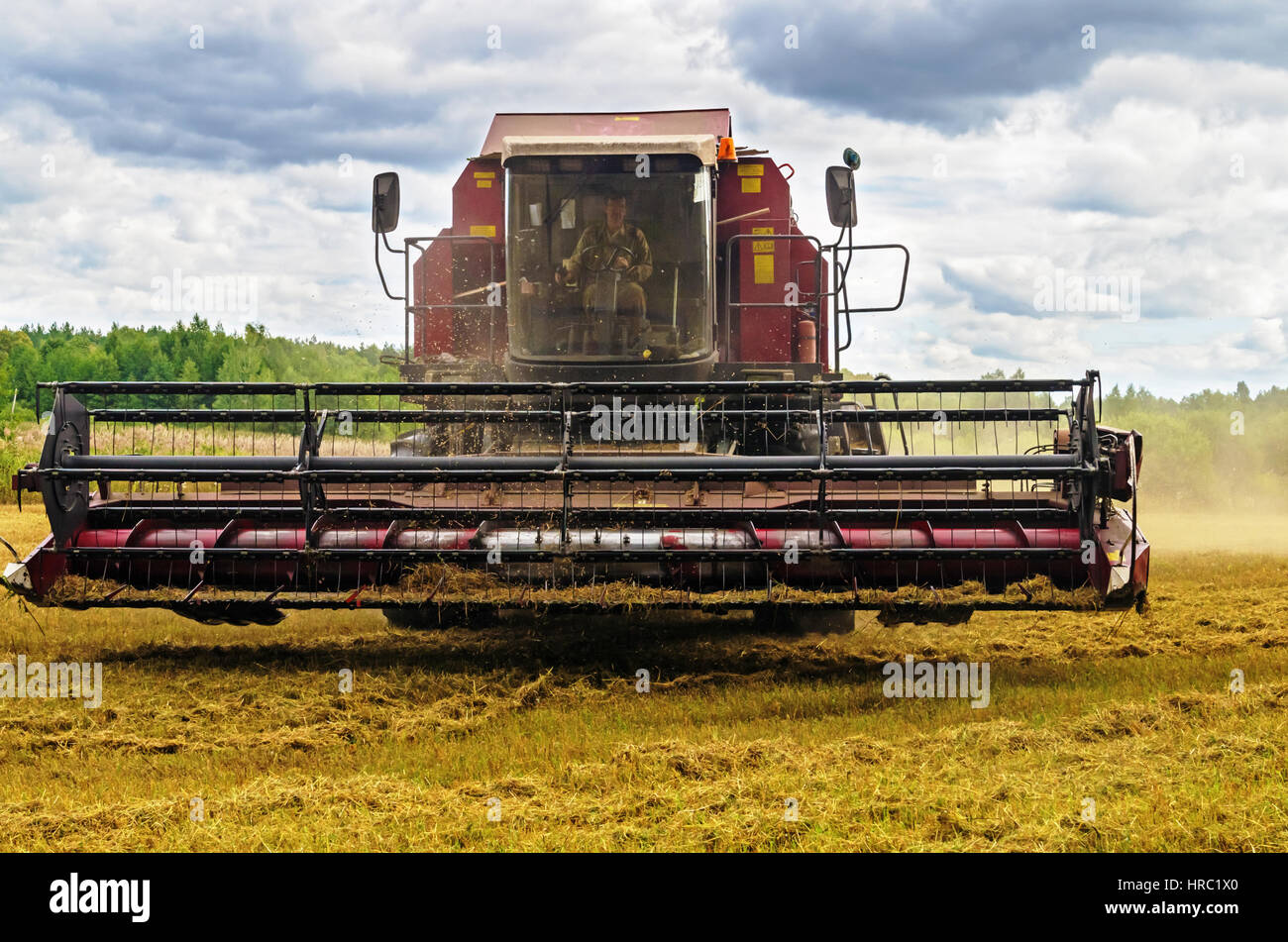 Cleaning agricultural field by harvester Stock Photo - Alamy