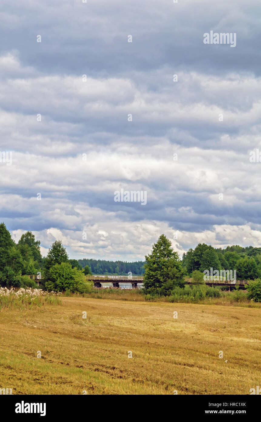 Landscape view - agricultural field and wooden bridge Stock Photo - Alamy