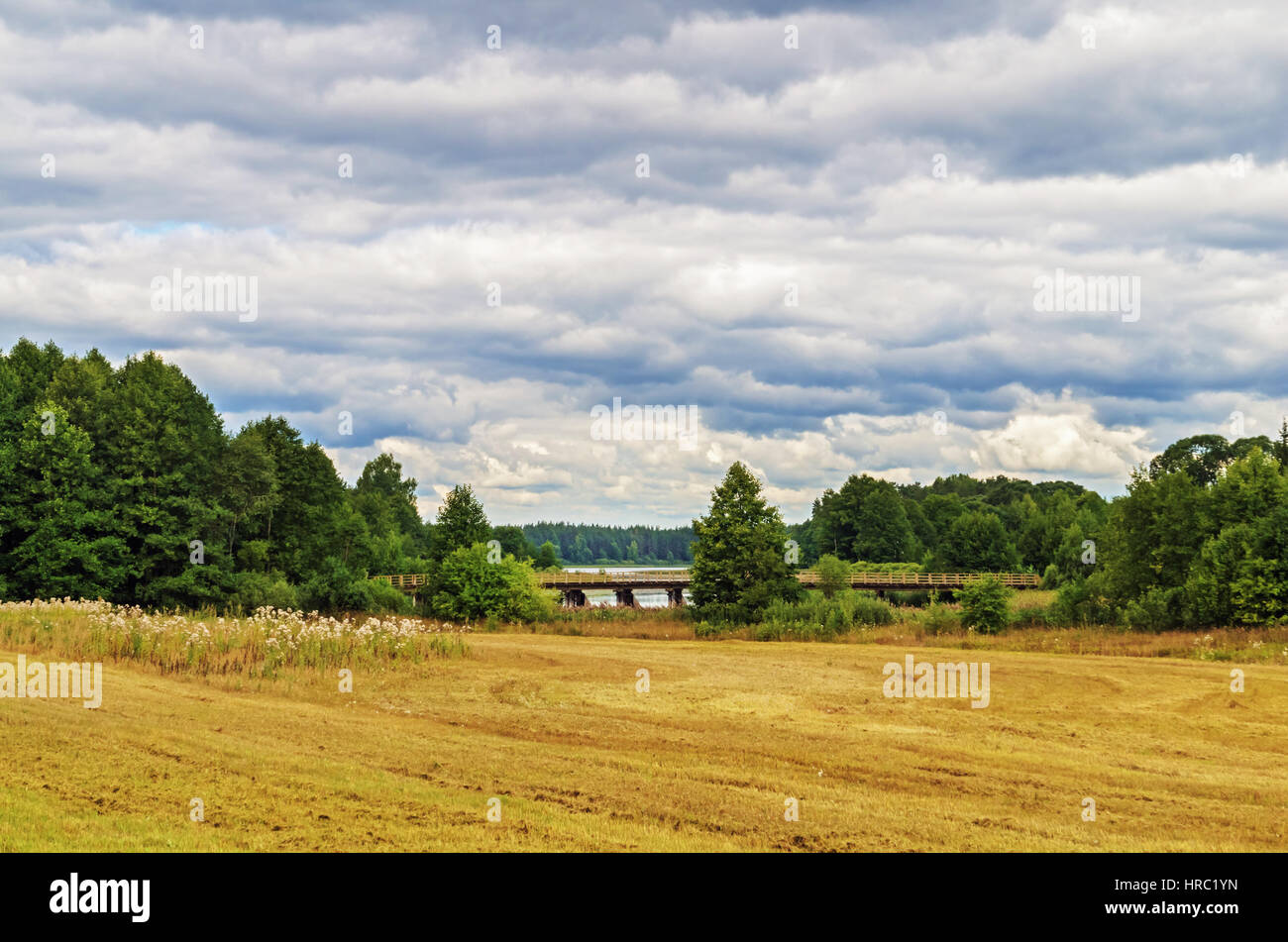 Landscape view - agricultural field and wooden bridge Stock Photo - Alamy