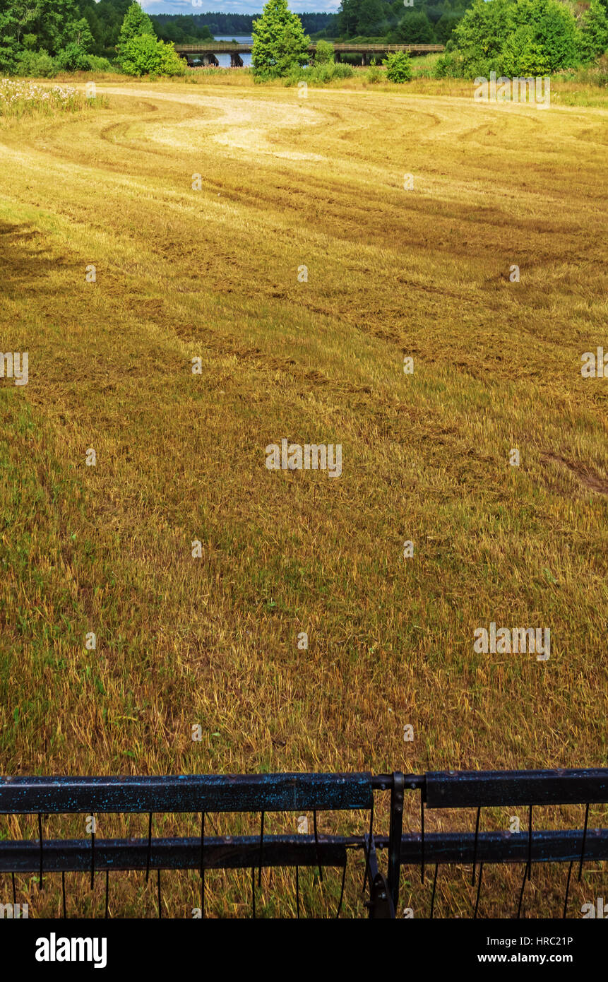 Cleaning agricultural field by harvester Stock Photo - Alamy