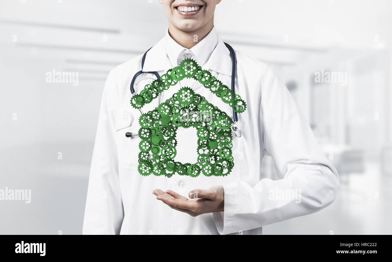 Hand of woman doctor showing house or home gear sign in palm Stock ...