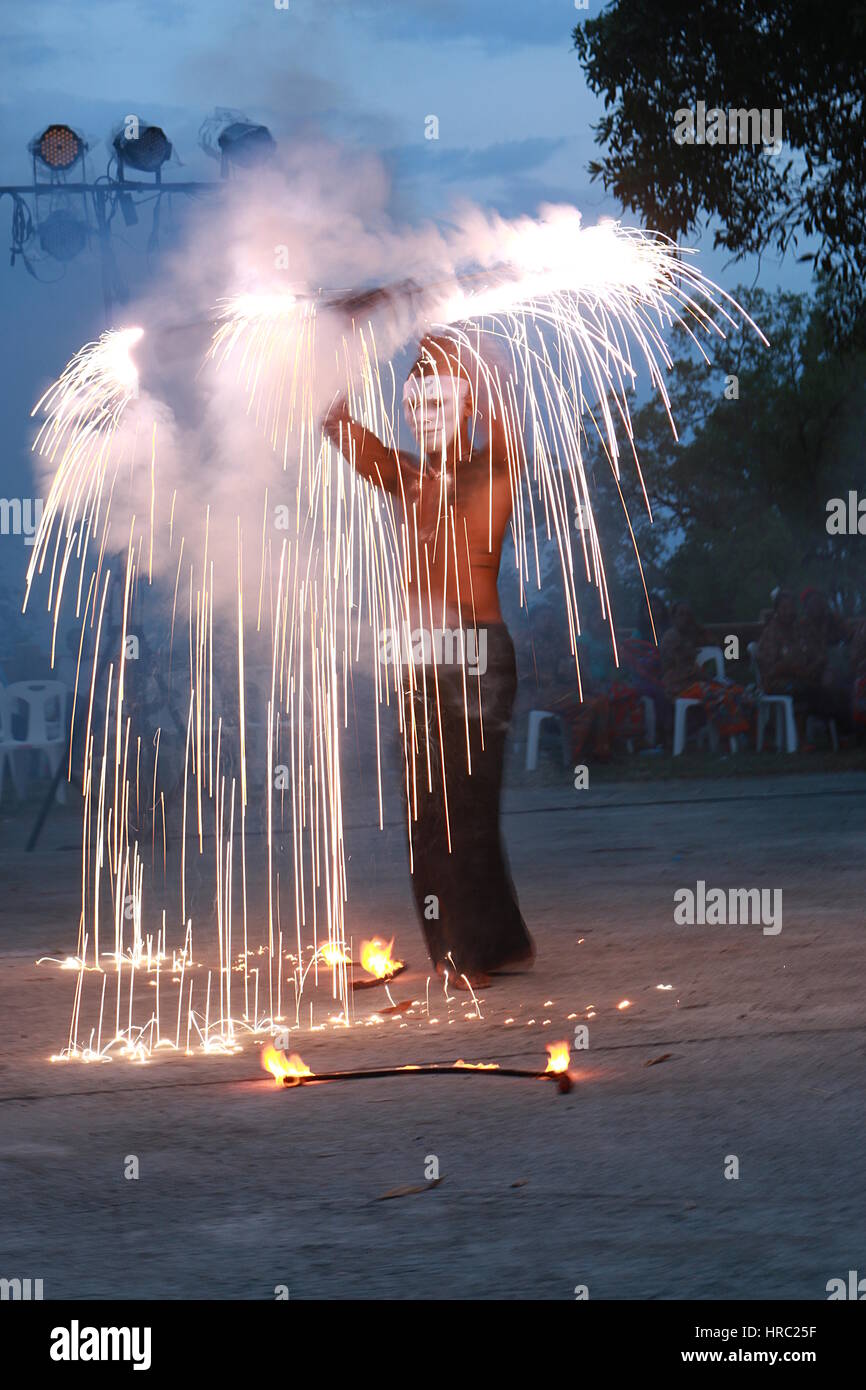 Fire dancer using petrol/gasoline (yellow flames) and fireworks (white ...
