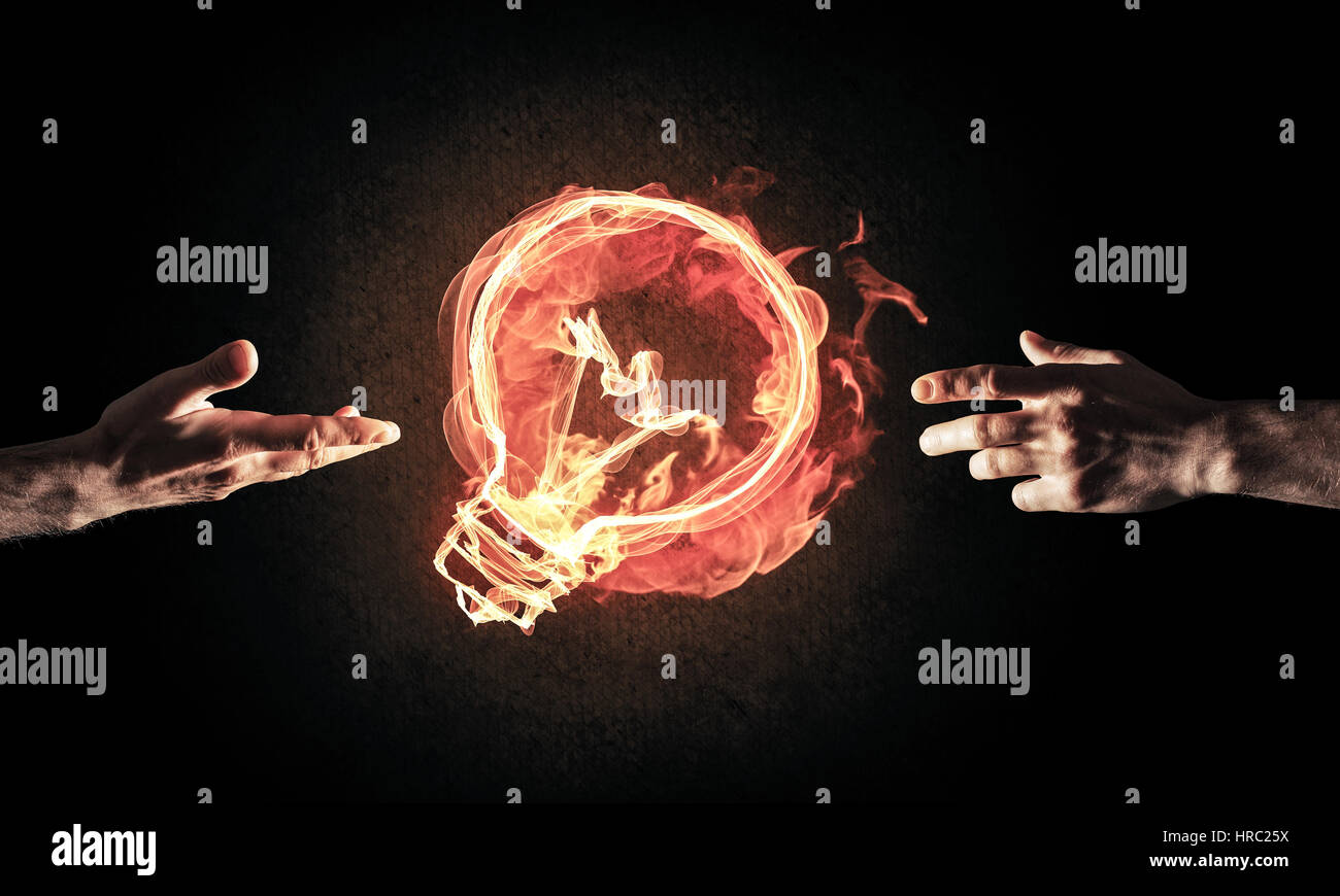 Close of businessman hand showing at glowing fire light bulb icon Stock ...